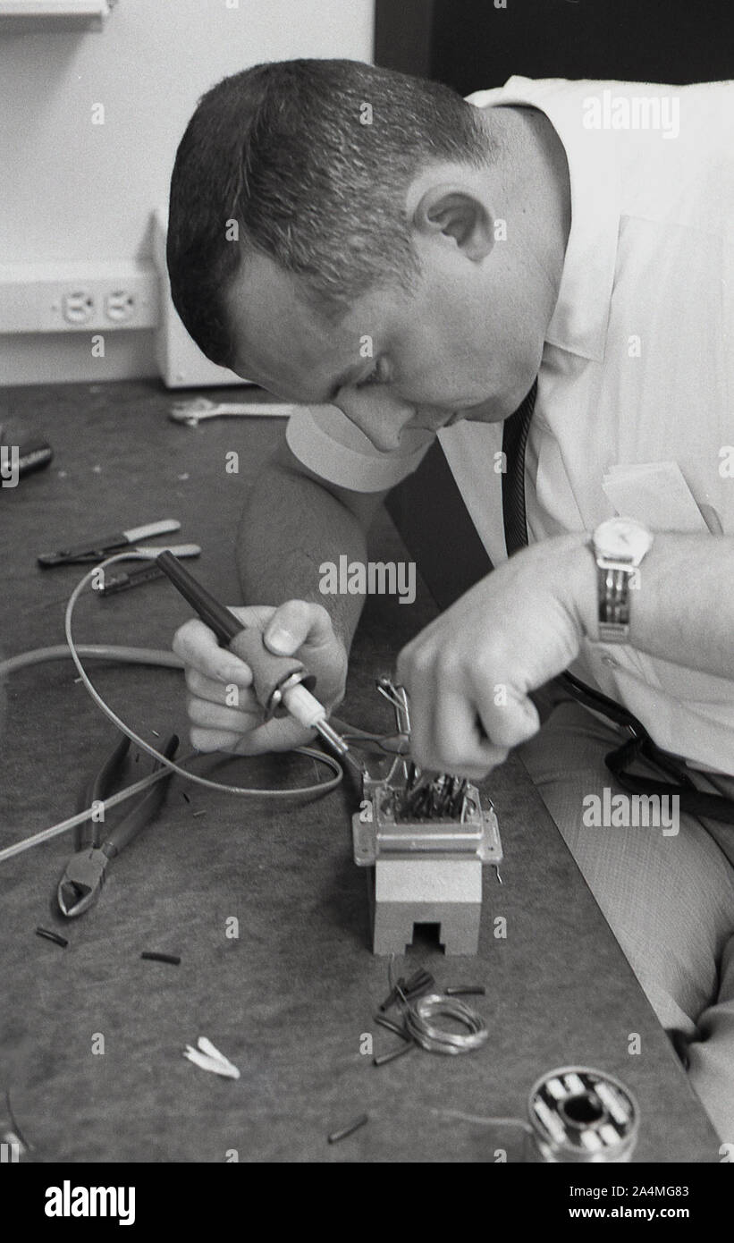1960s, historical, an adult student working in a workshop, using a ...