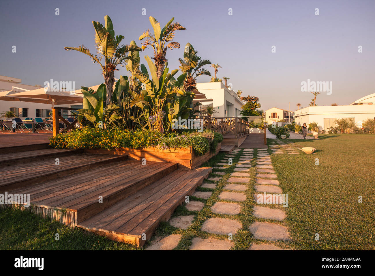 Resort garden at sunset 3 Stock Photo - Alamy
