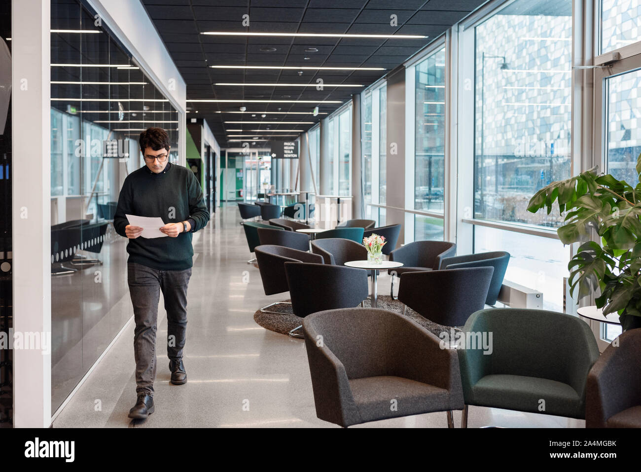 Man walking in office Stock Photo - Alamy