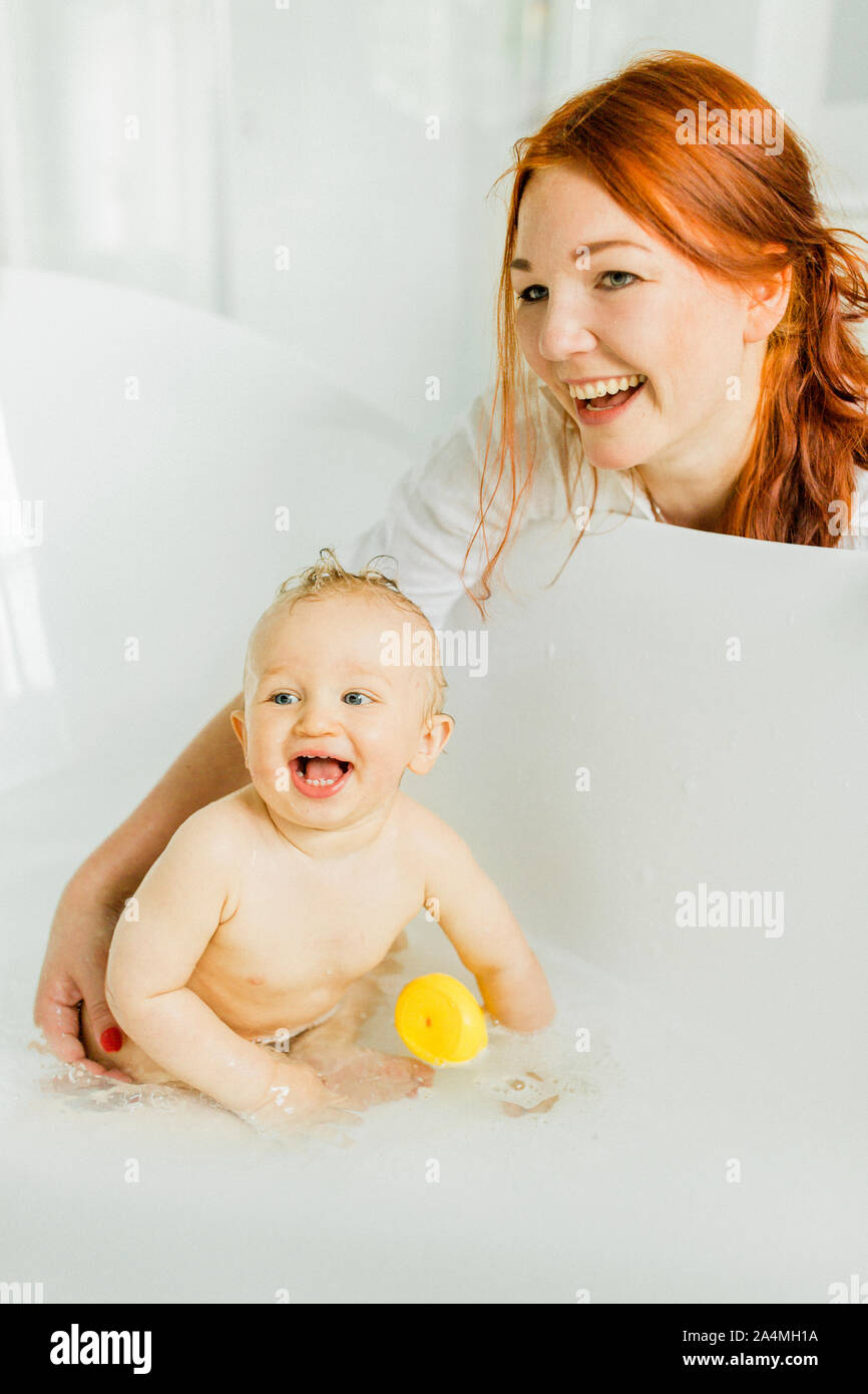 Mother with baby in bath Stock Photo - Alamy