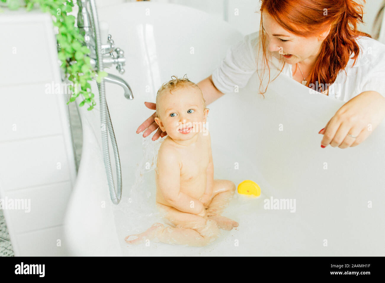 Mother with baby in bath Stock Photo - Alamy