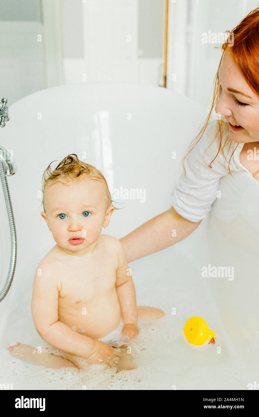 Mother with baby in bath Stock Photo - Alamy