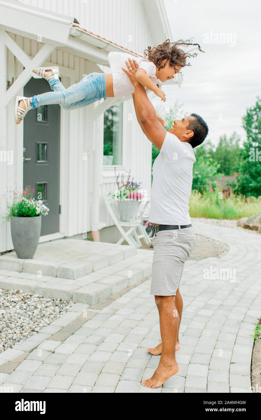 Father holding daughter aloft Stock Photo - Alamy
