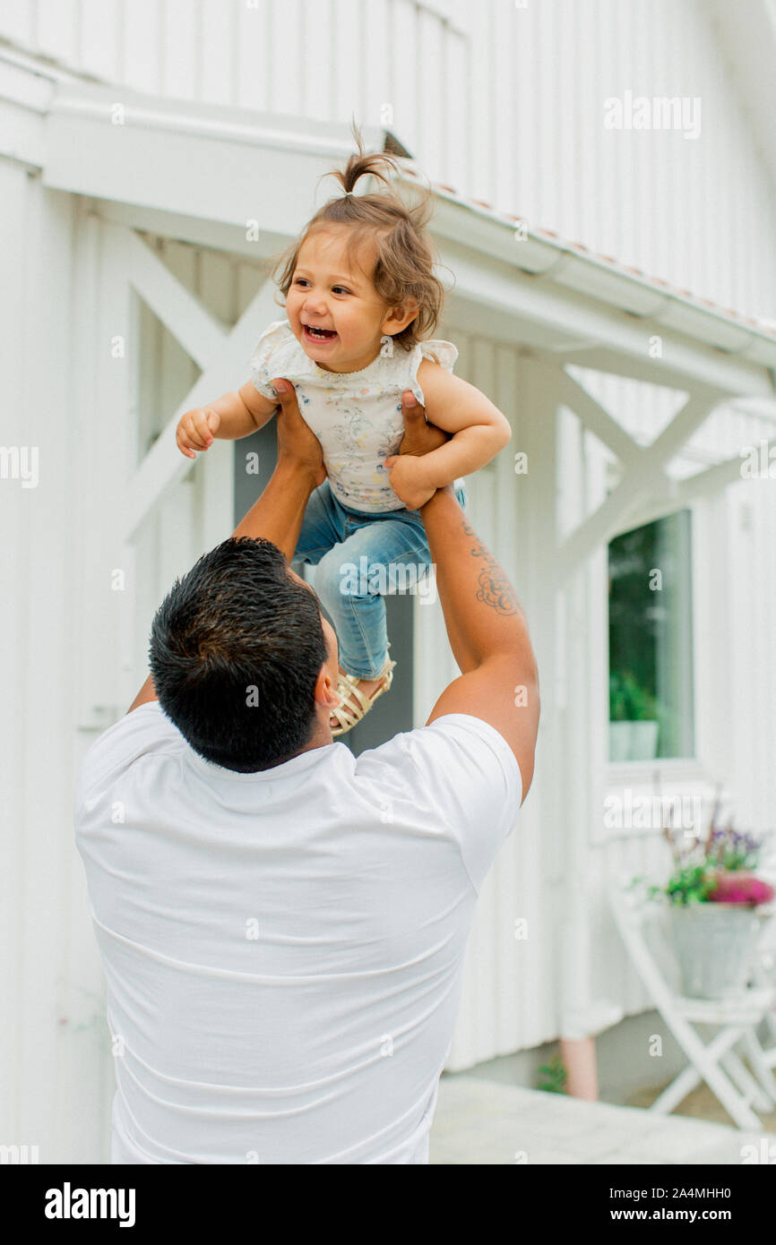 Father holding daughter aloft Stock Photo - Alamy