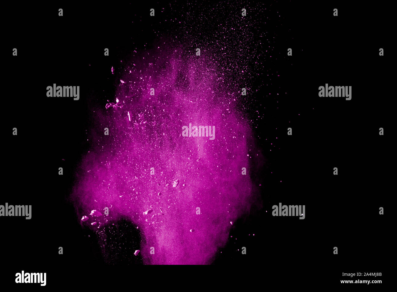 Abstract pink dust explosion on black background. Freeze motion of pink ...