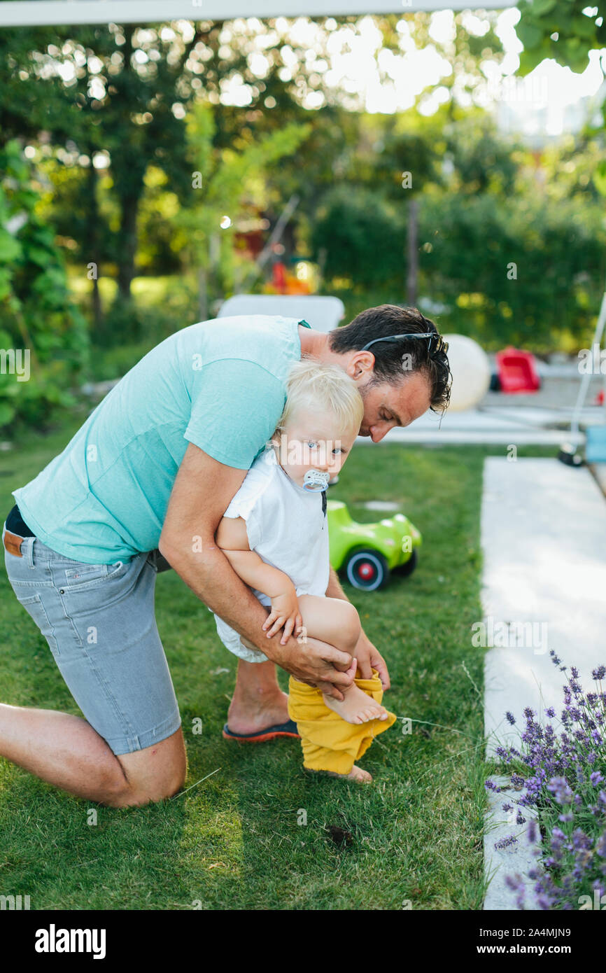 Father helping son dressing up Stock Photo - Alamy
