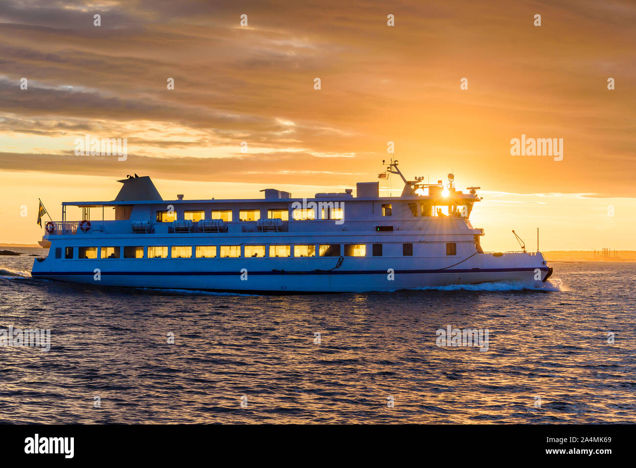 Ferry at sunset Stock Photo - Alamy
