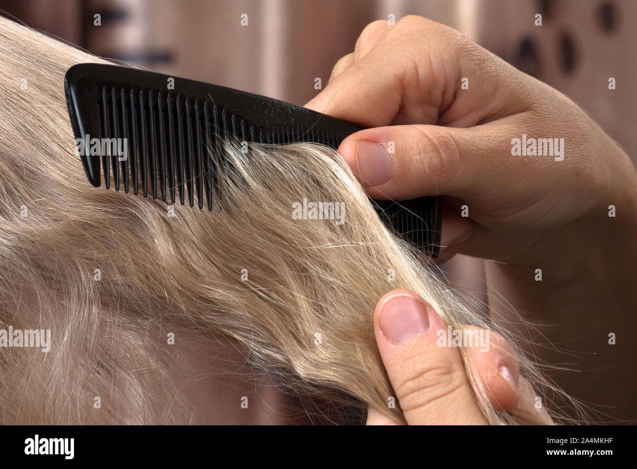 hands of woman combing hair her daughter, closeup Stock Photo - Alamy