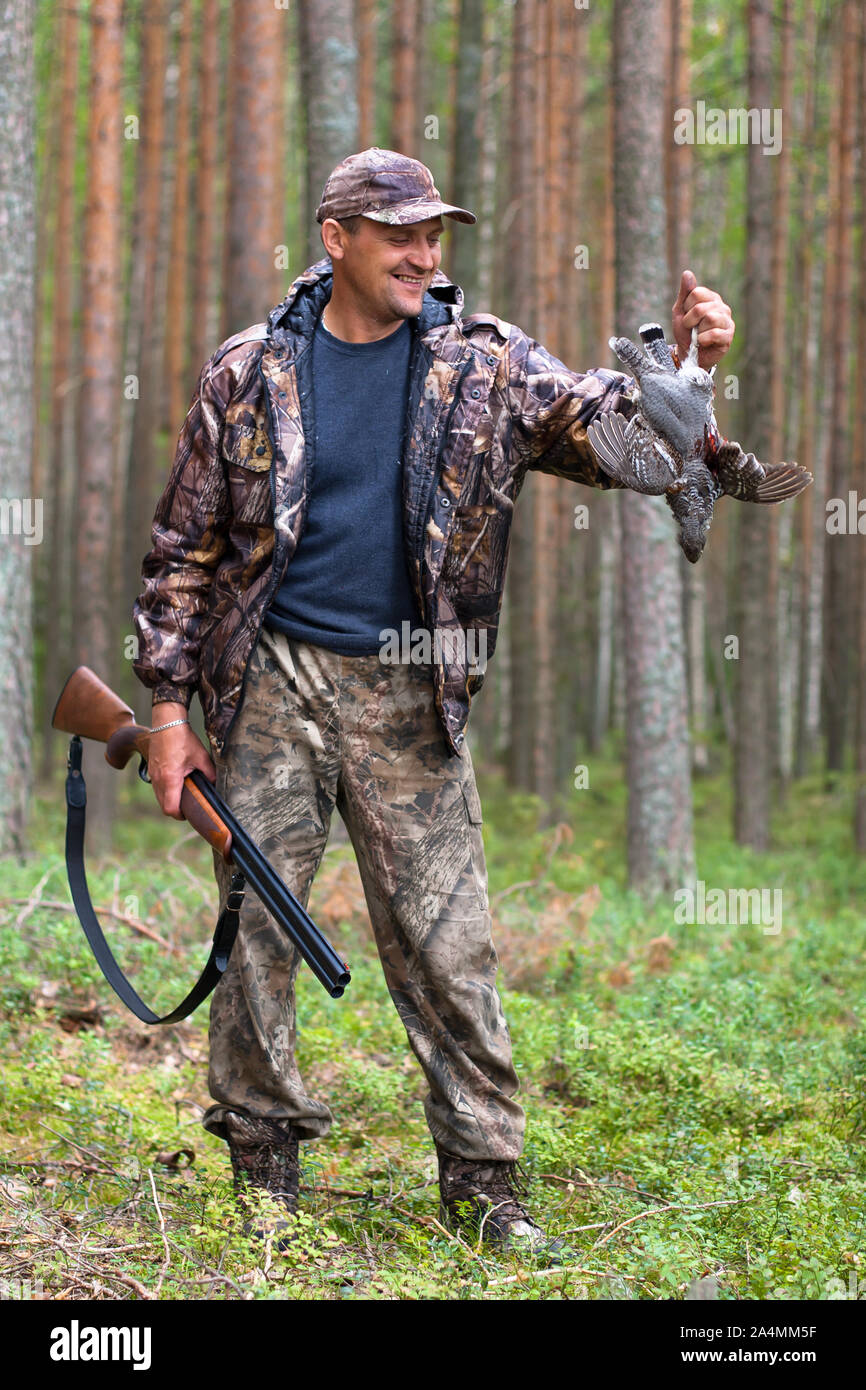 hunter with gun and wildfowl in the forest Stock Photo - Alamy