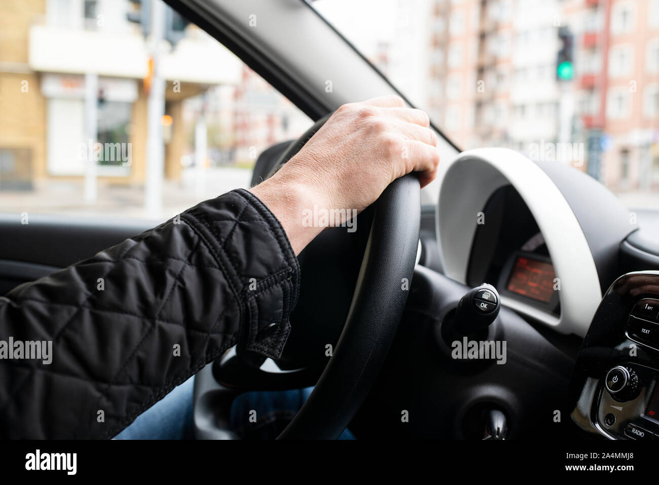 Hand on steering wheel Stock Photo - Alamy
