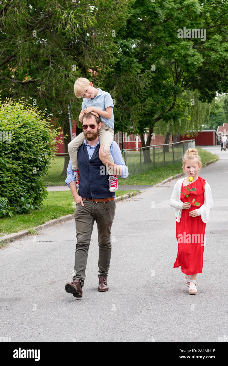 Father walking with children Stock Photo - Alamy