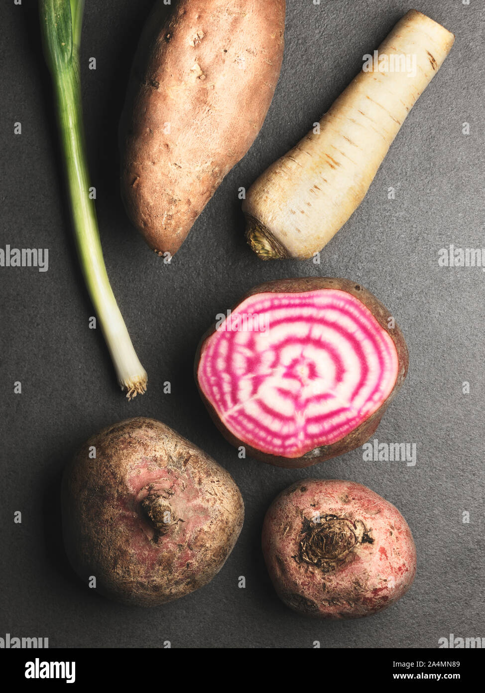 Root vegetables on grey background Stock Photo - Alamy