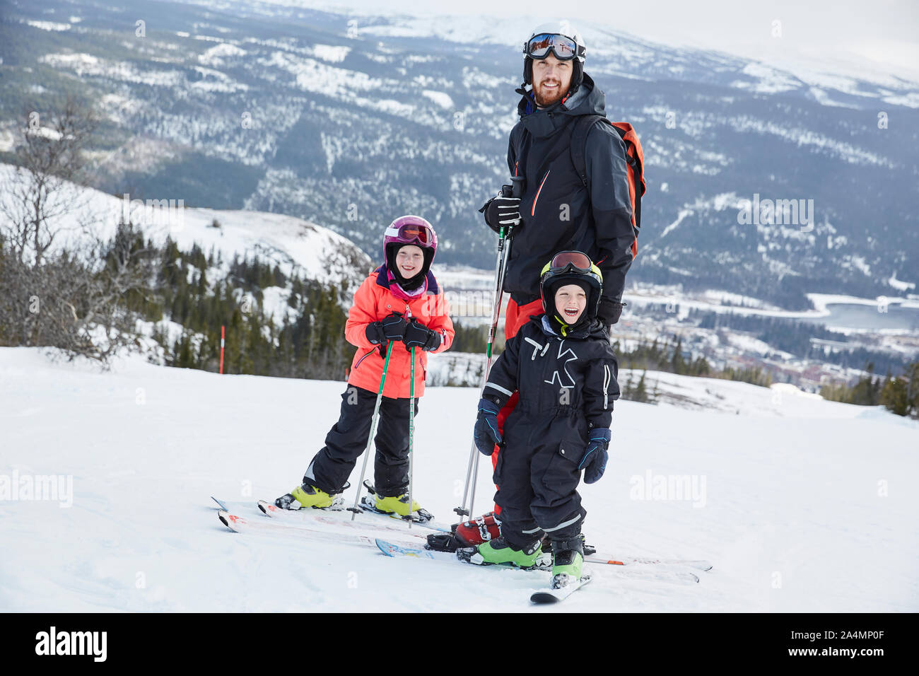 Father and sons skiing Stock Photo - Alamy