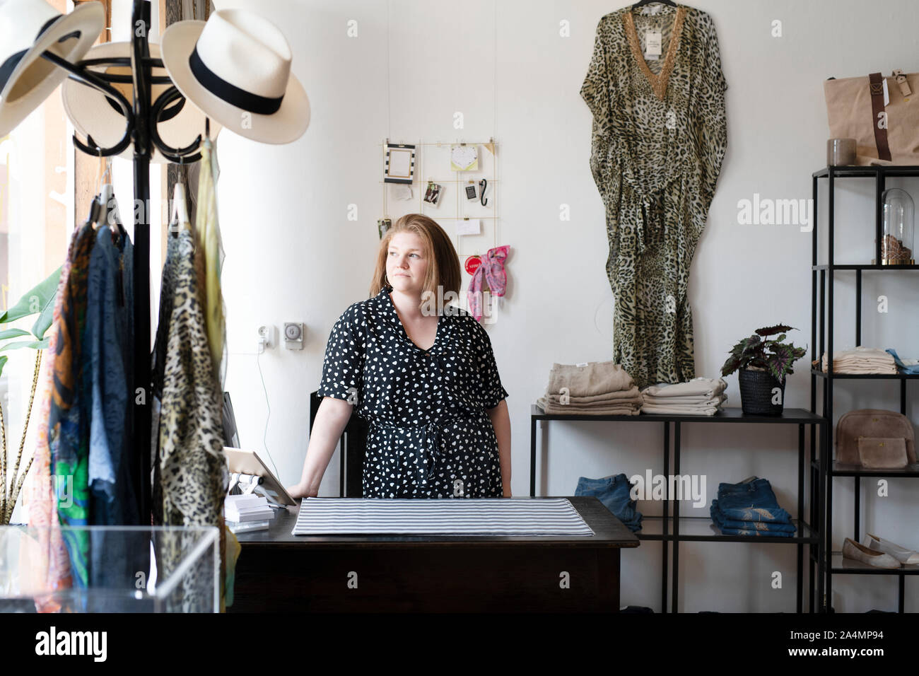 Woman in clothes shop Stock Photo - Alamy
