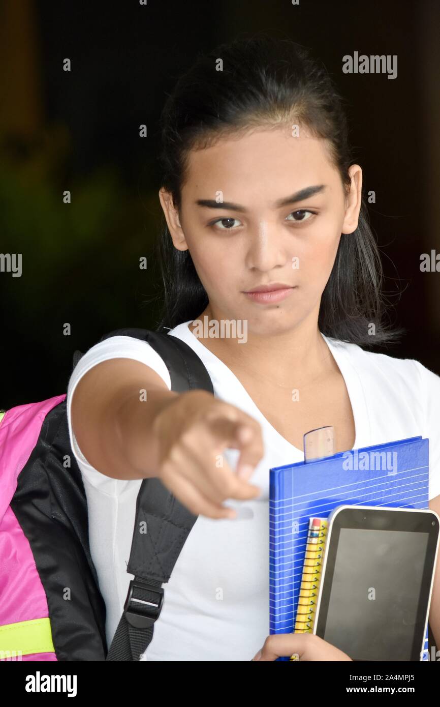 Cute Girl Student Pointing With Books Stock Photo - Alamy