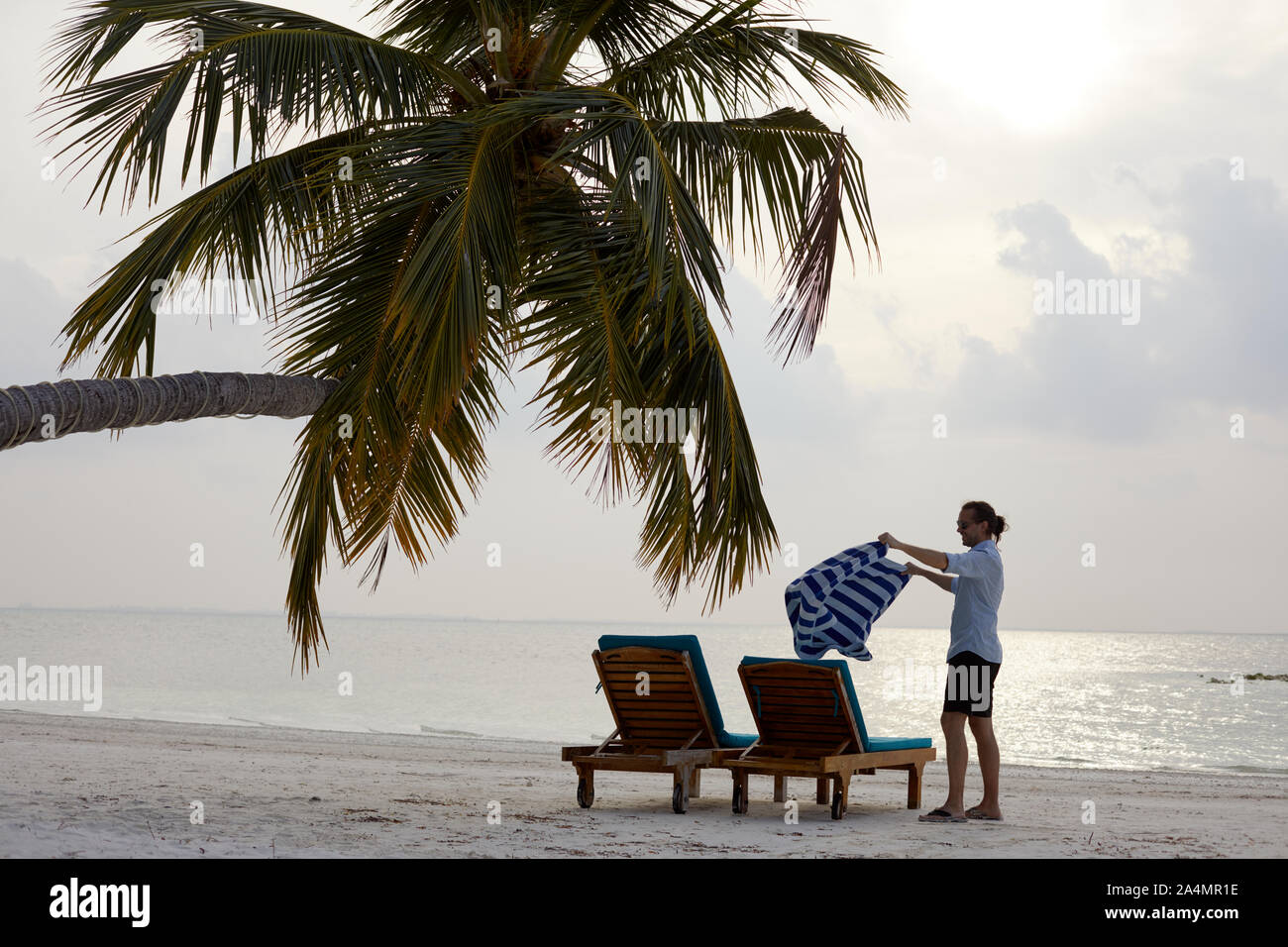 Man on beach towel hi-res stock photography and images - Alamy