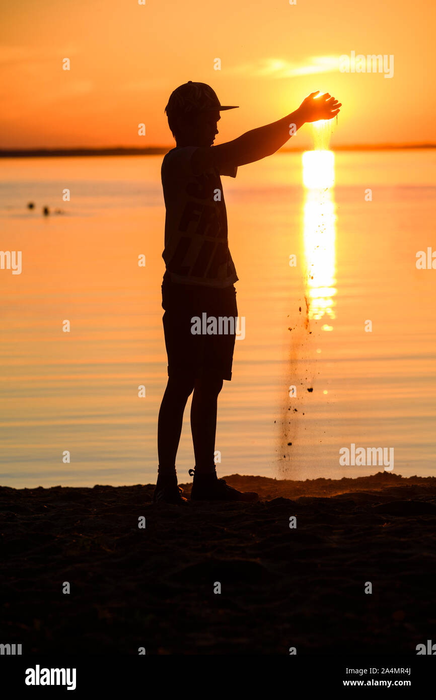 Boy playing on beach Stock Photo - Alamy