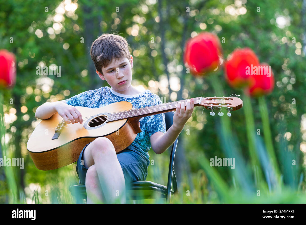Boy playing guitar Stock Photo - Alamy