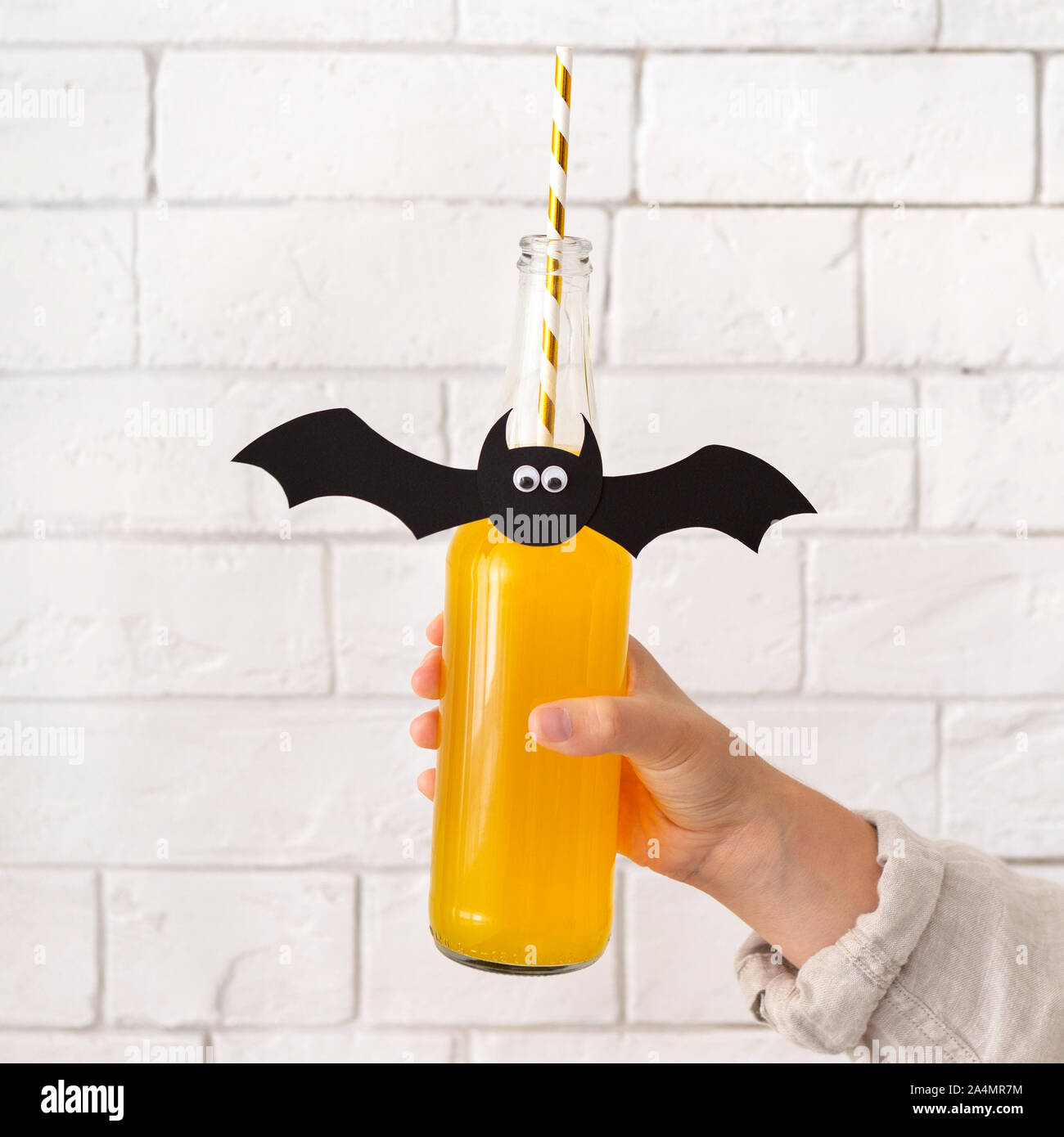 Close up of glass bottle with paper bat decoration Stock Photo - Alamy