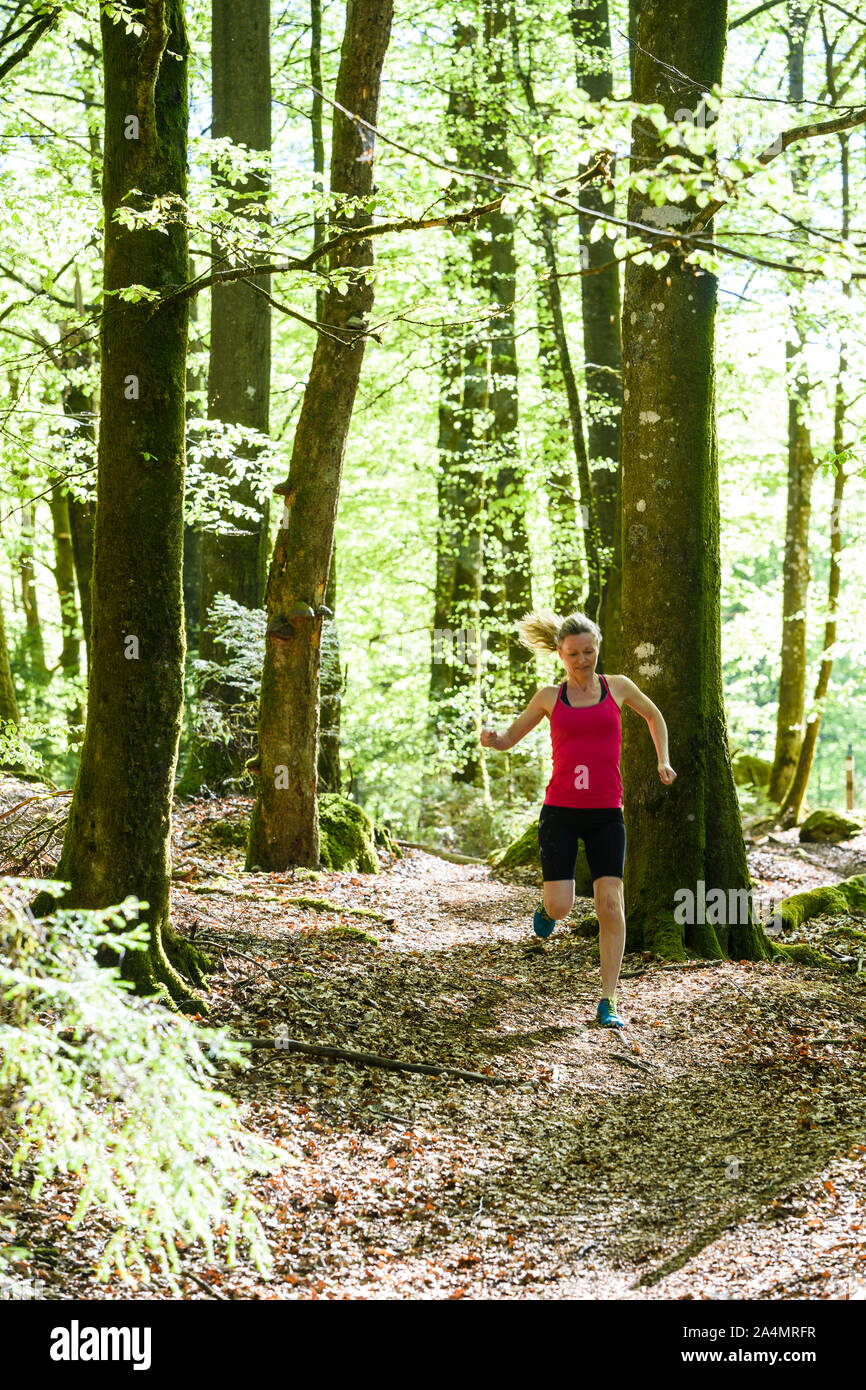 Woman jogging in forest hi-res stock photography and images - Alamy