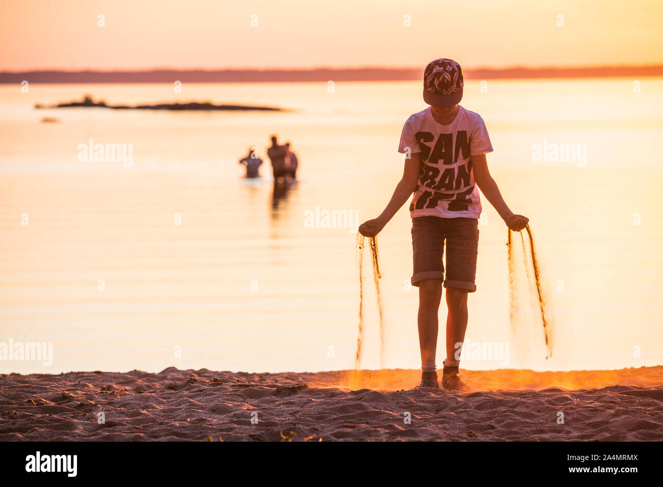 Boy playing on beach Stock Photo - Alamy