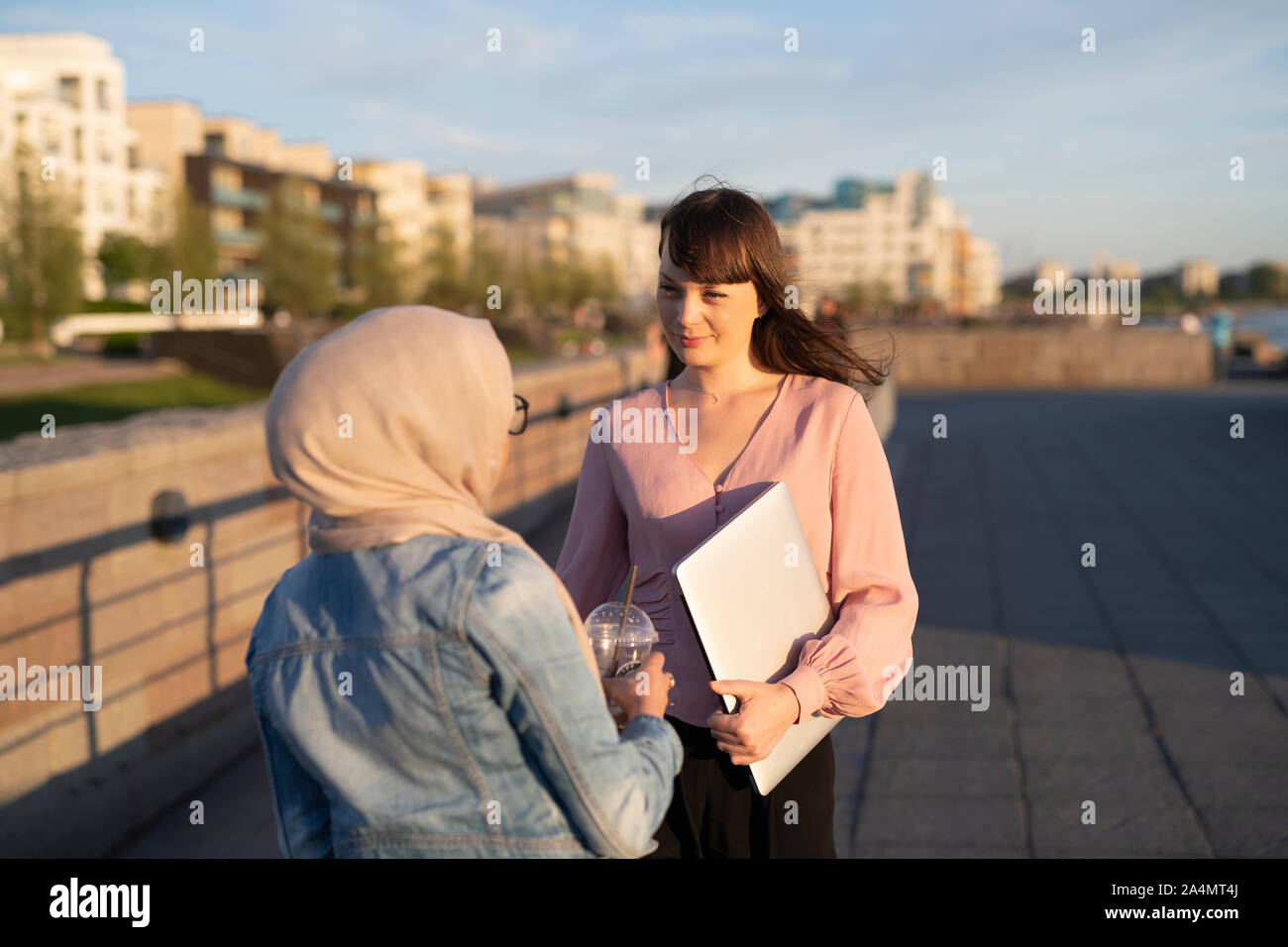 Female friends talking Stock Photo - Alamy