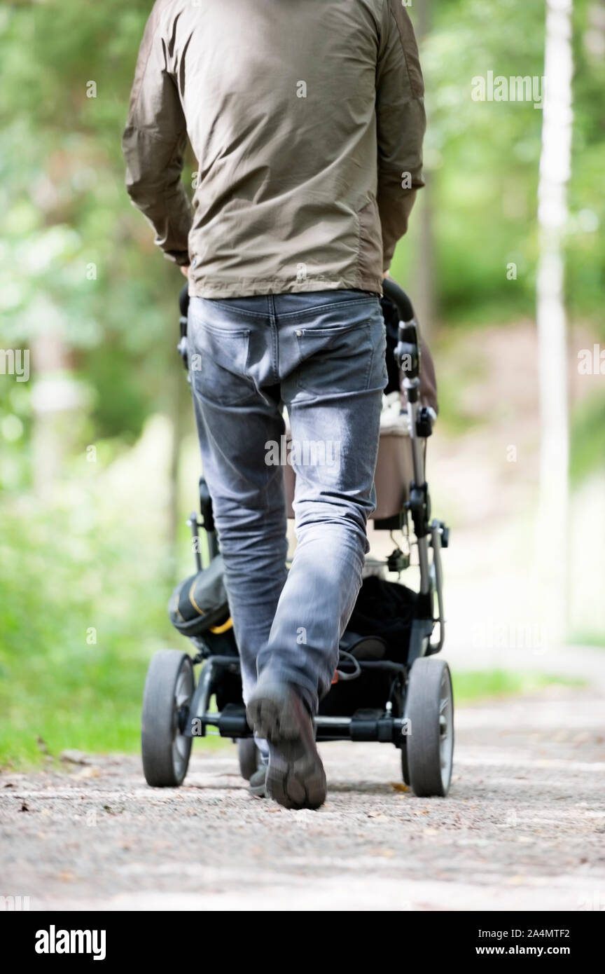 Man walking with pram, low section Stock Photo - Alamy