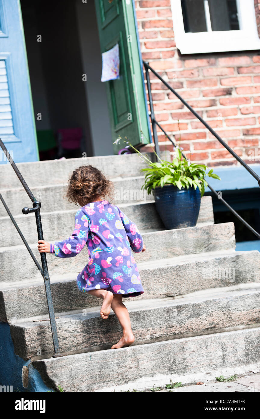 Girl walking up stairs Stock Photo - Alamy