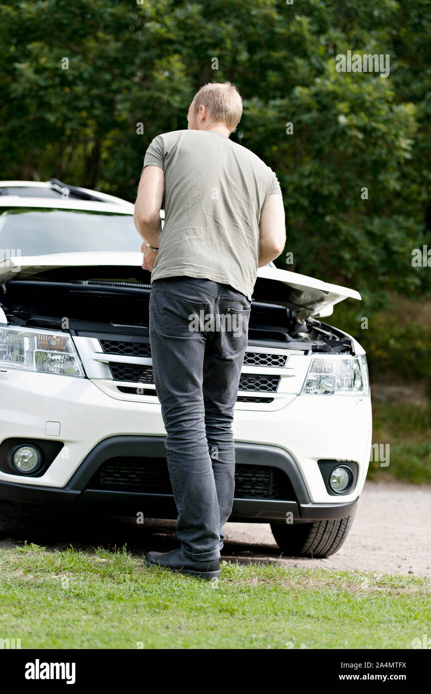 Man opening car bonnet Stock Photo - Alamy