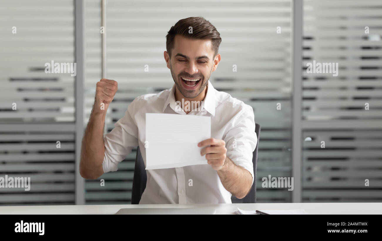 Happy businessman reading document, business letter, excited by good ...