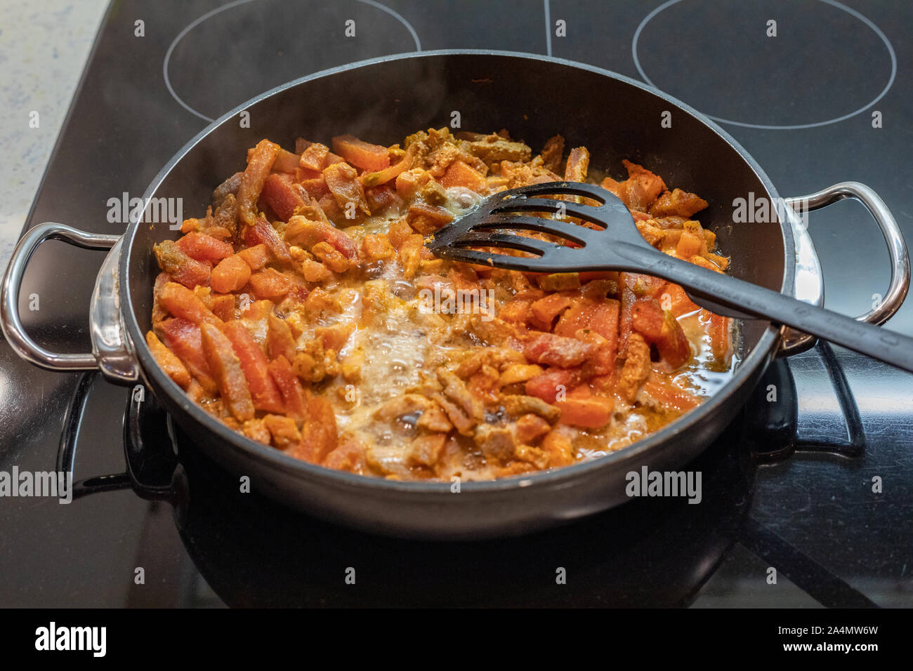 Frying gyros in a pan Stock Photo - Alamy