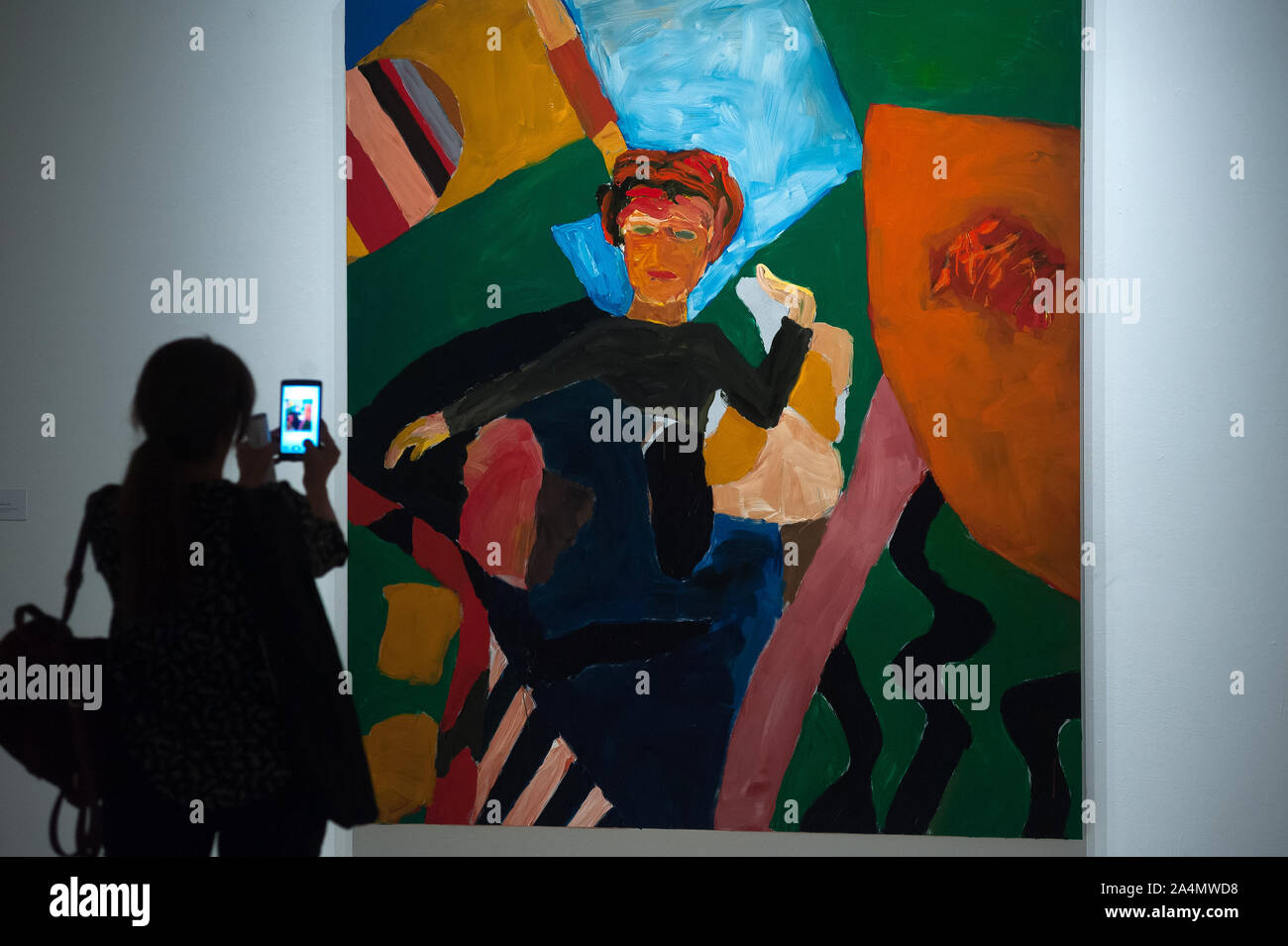 Malaga, Spain. 15th Oct, 2019. A visitor takes a photo of a painting ...