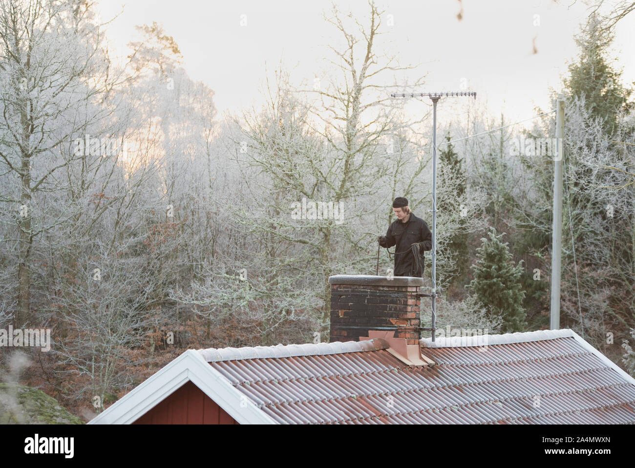 Chimney Sweep cleaning chimney Stock Photo - Alamy