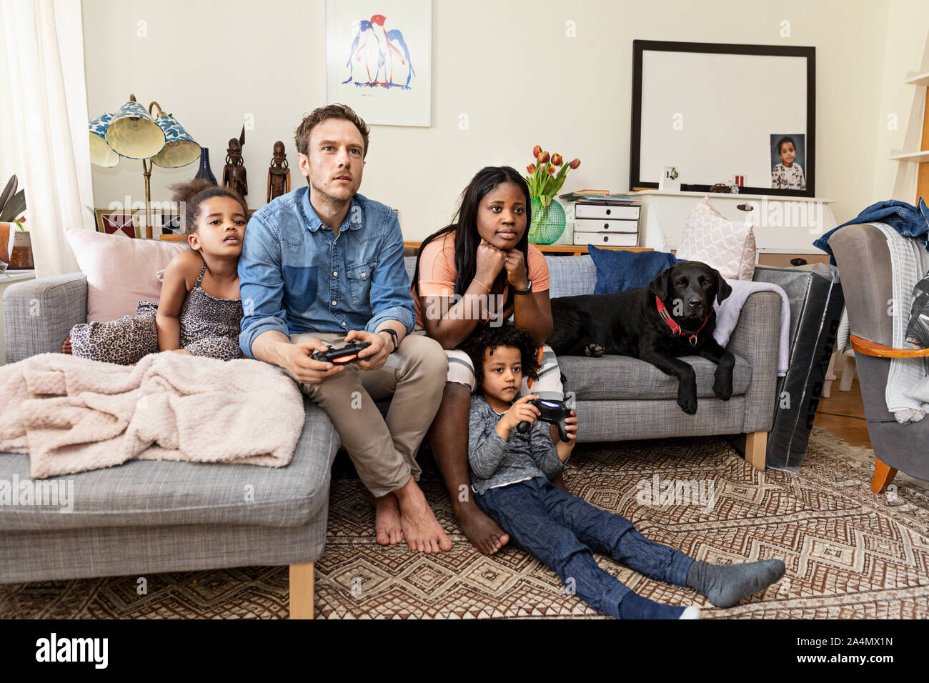 Family playing video game Stock Photo - Alamy