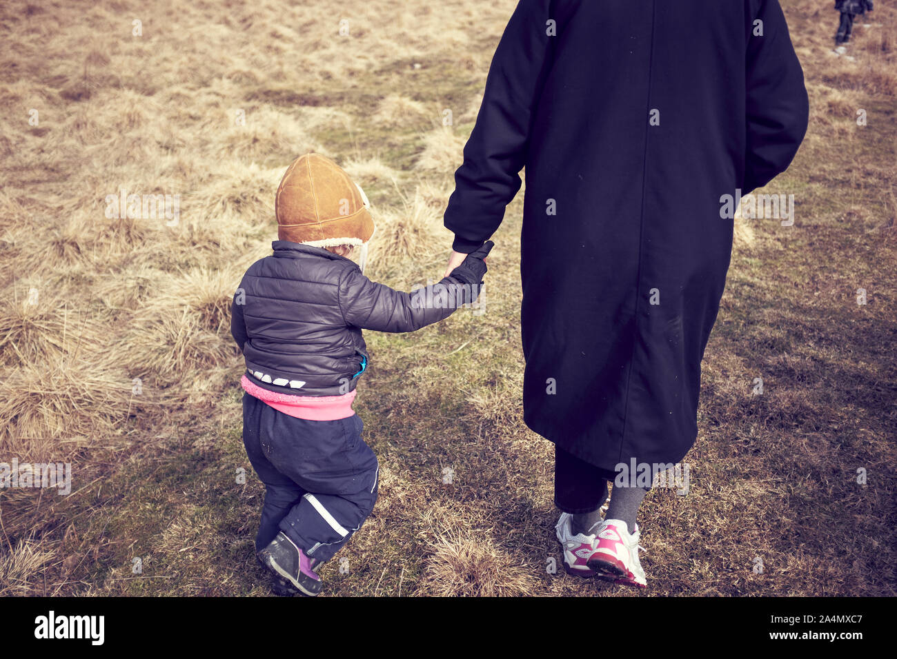 Mother and toddler walking Stock Photo - Alamy