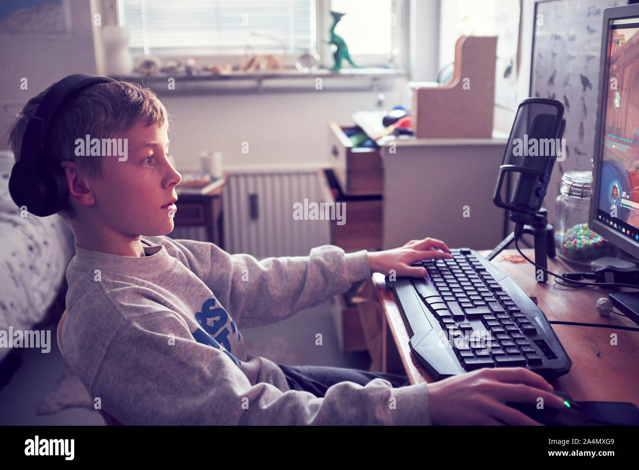 Boy using computer Stock Photo - Alamy