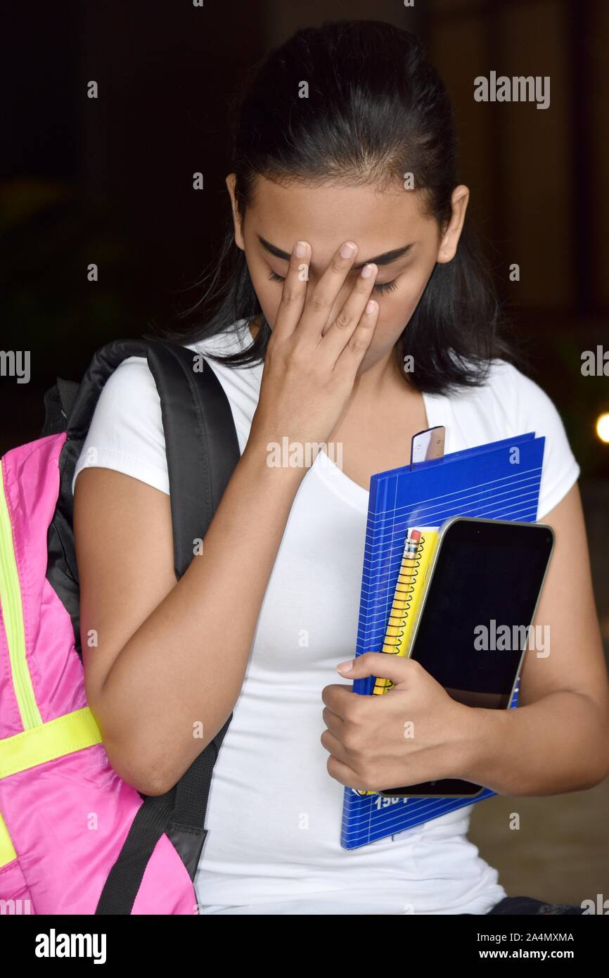 Cute Girl Student And Sadness With Books Stock Photo - Alamy