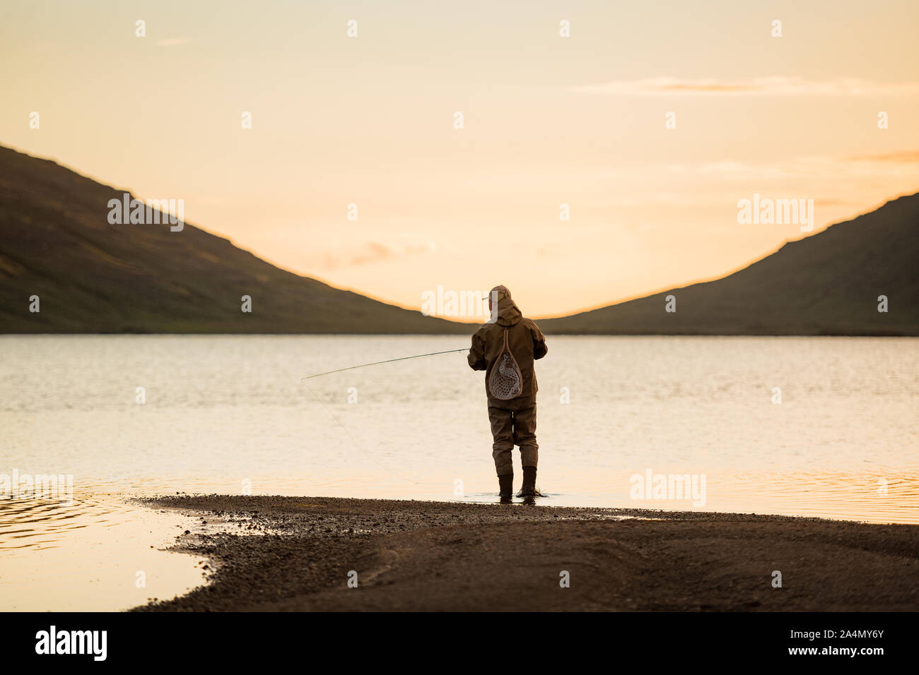 Man fishing in lake Stock Photo - Alamy