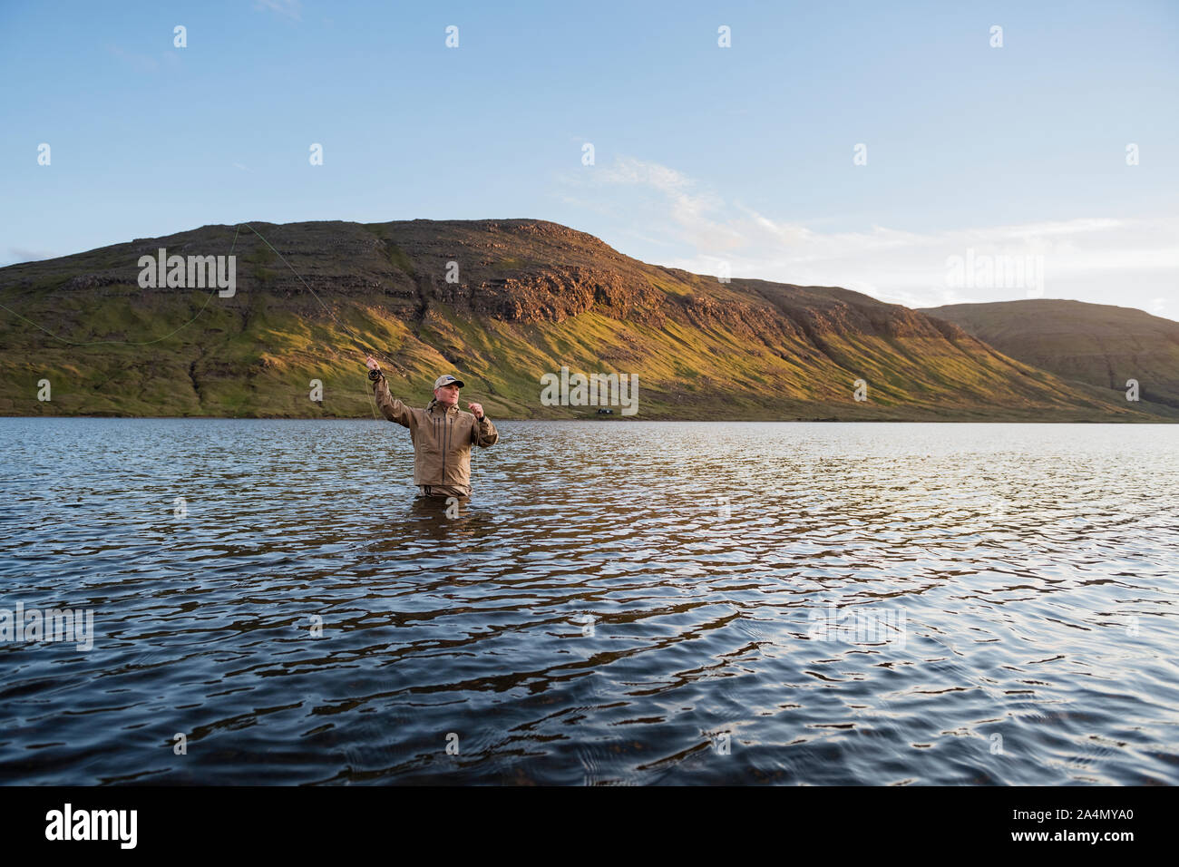Man fishing in lake Stock Photo - Alamy