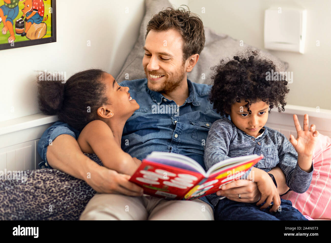 Father reading book to children Stock Photo - Alamy