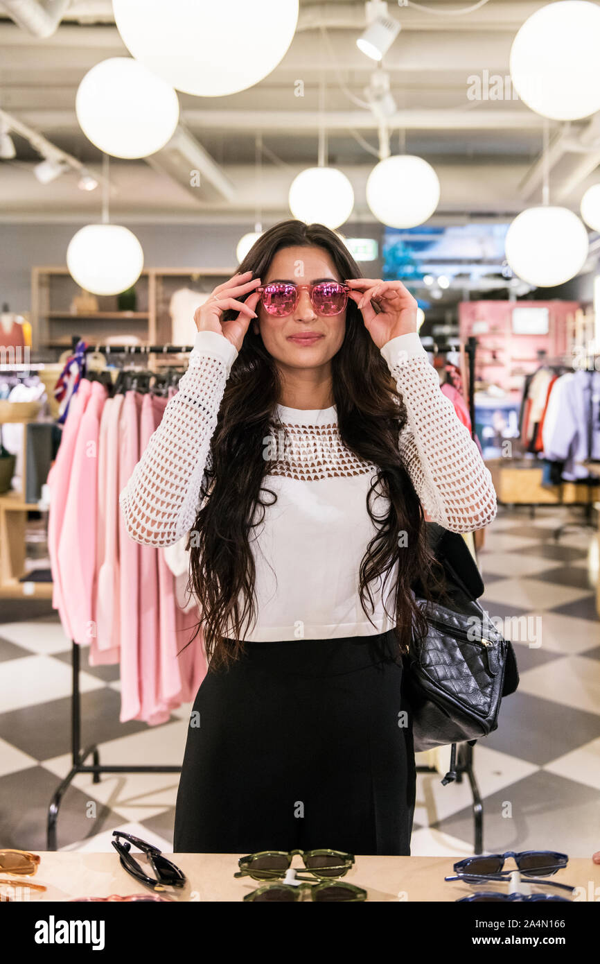 Woman trying on clothes shop hi-res stock photography and images - Alamy