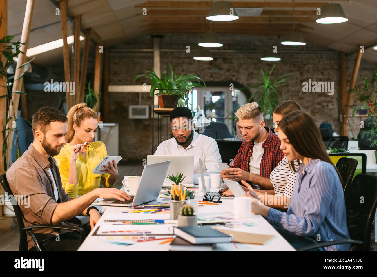 Working process. Young designers working on project Stock Photo - Alamy