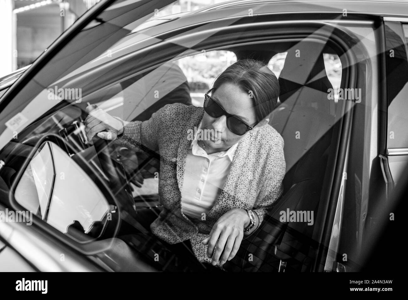 Woman leaving car Stock Photo - Alamy