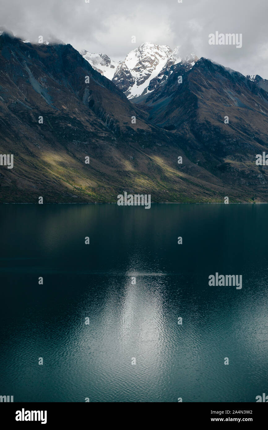 Mountains reflecting in water Stock Photo - Alamy