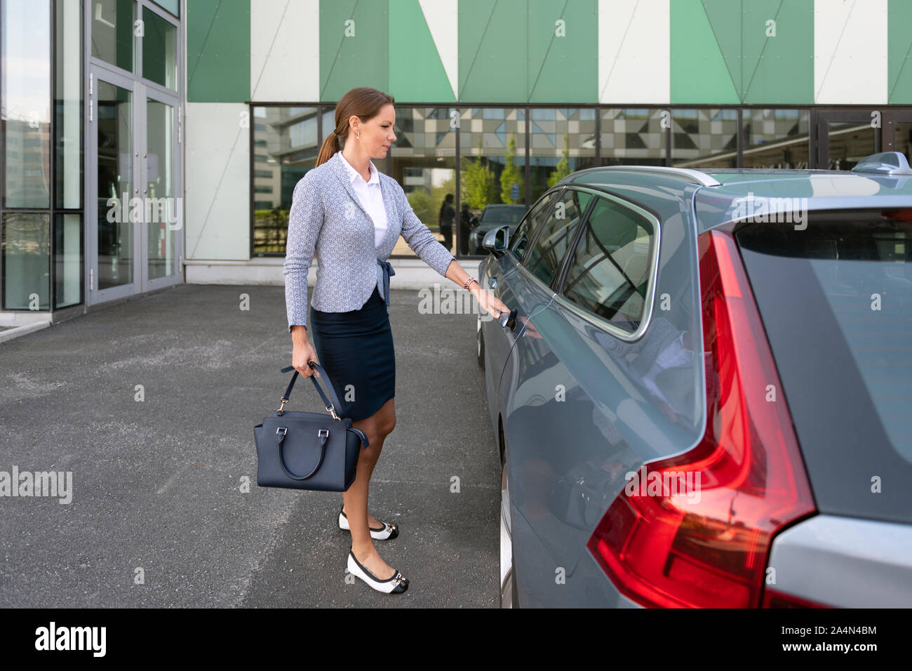 Woman opening car Stock Photo - Alamy