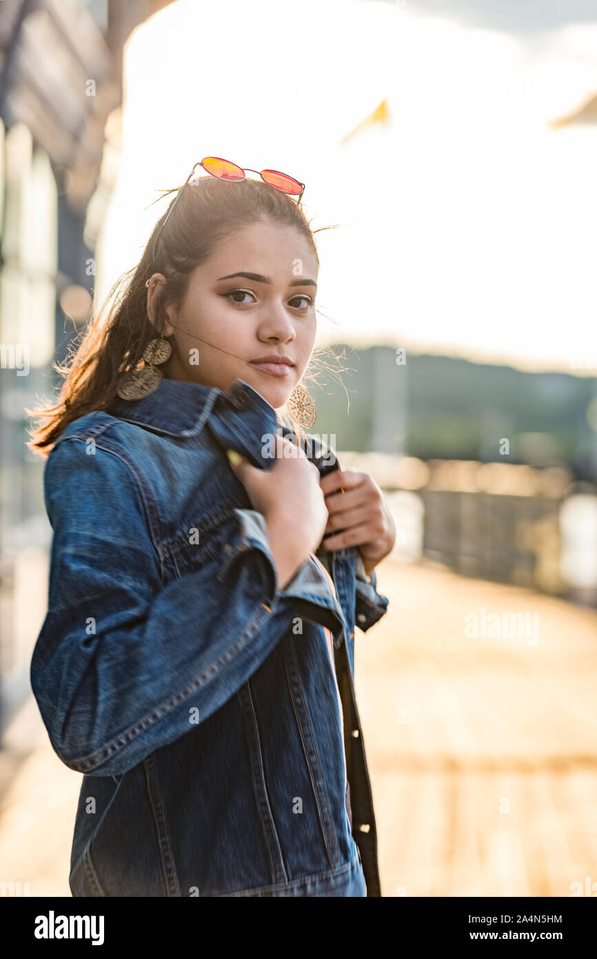 Teenage girl looking at camera Stock Photo - Alamy