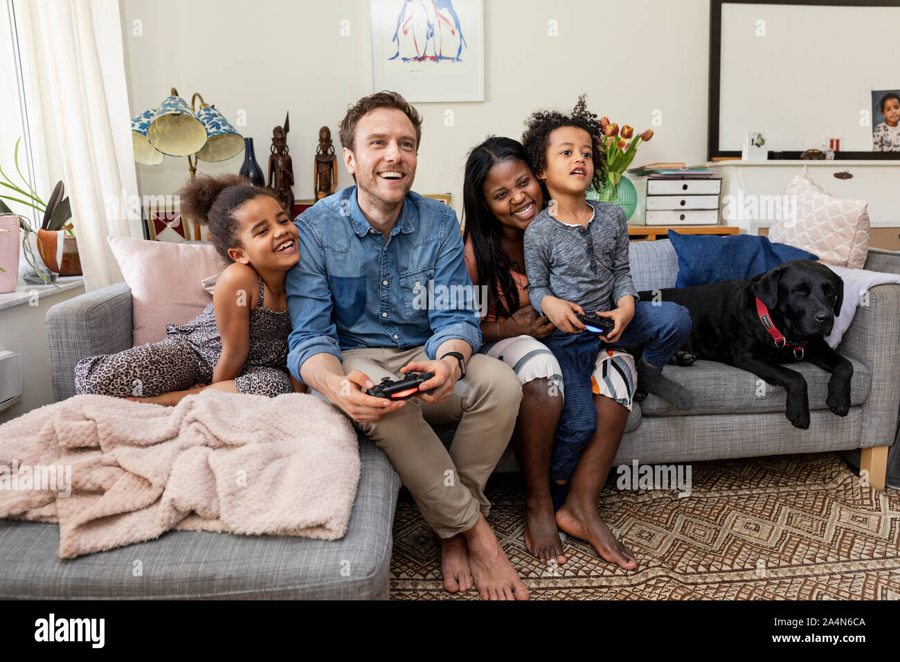 Family playing video game Stock Photo - Alamy