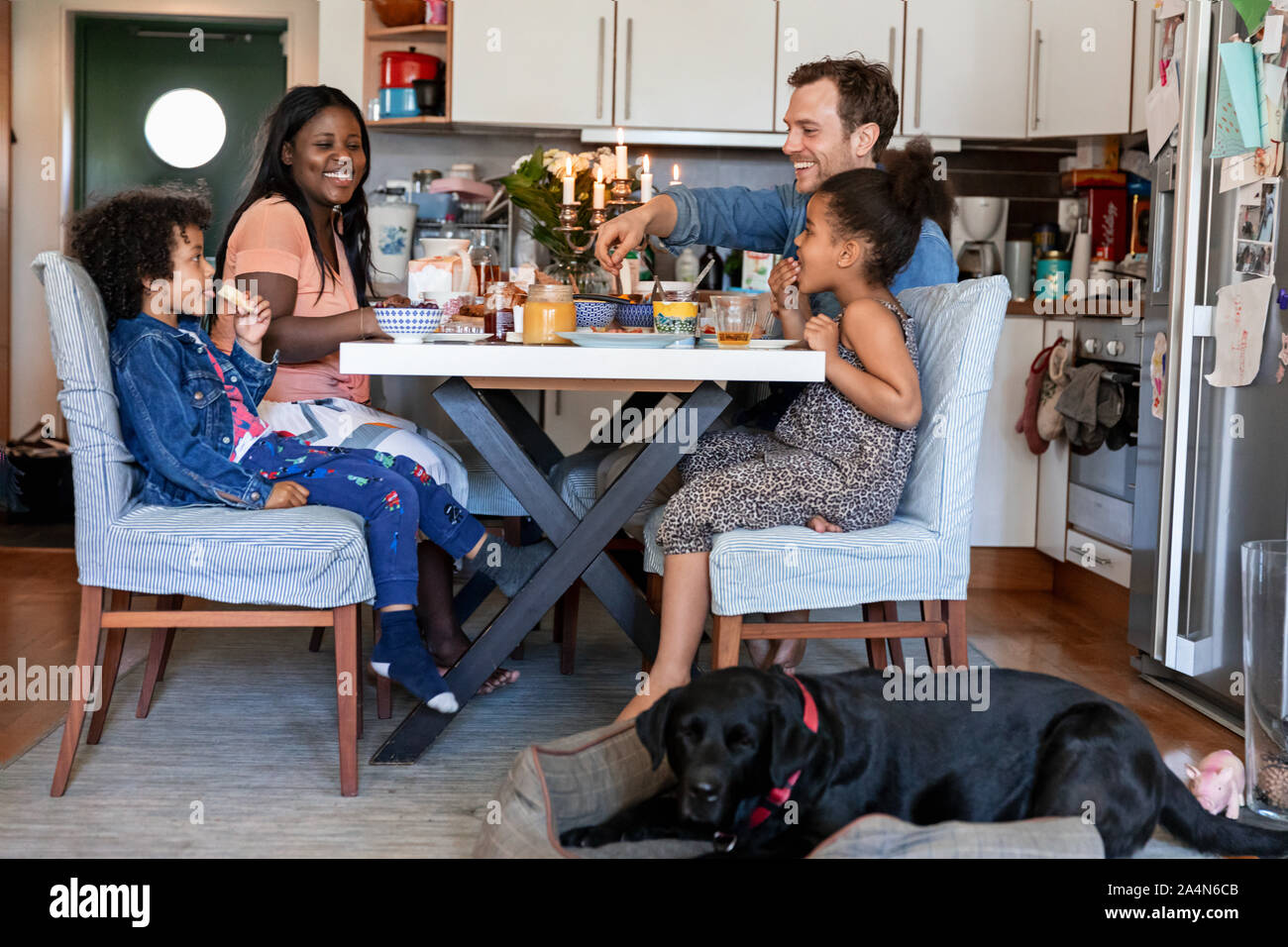 Family at table Stock Photo - Alamy
