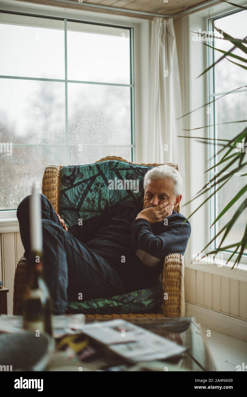 Old man sleeping on chair hi-res stock photography and images - Alamy