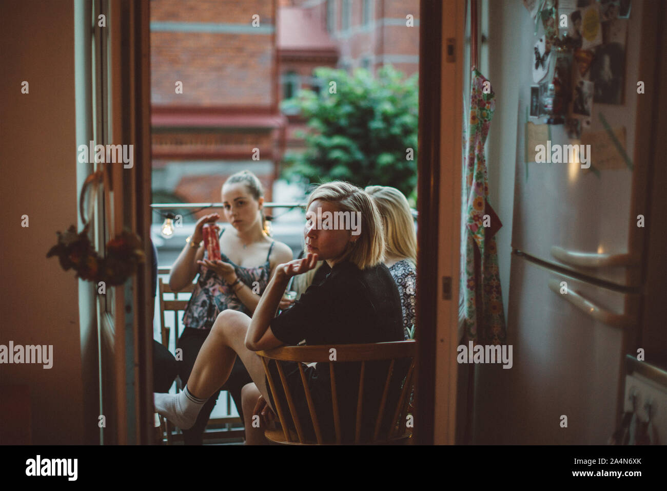 Women sitting on balcony Stock Photo - Alamy